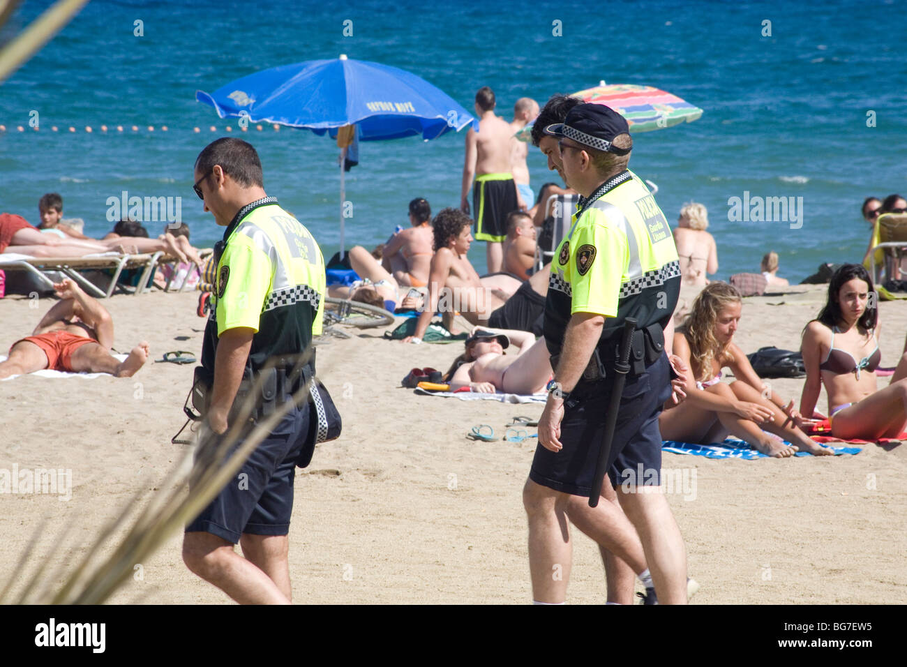 BEACH POLICE, TOURISTS SUNBATHING, BARCELONA: Barceloneta beach police ...