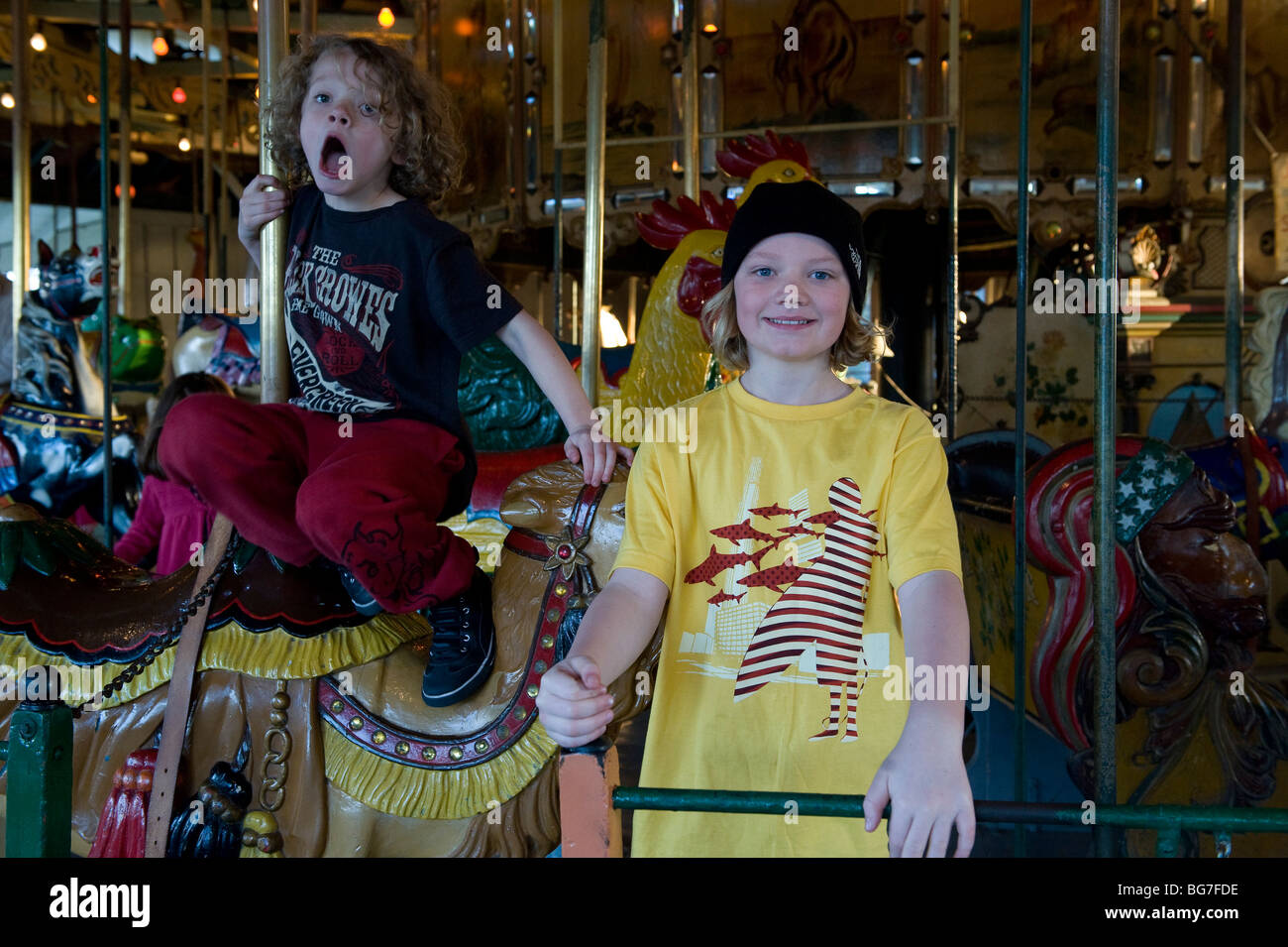 Children riding a beautiful carousel Stock Photo - Alamy