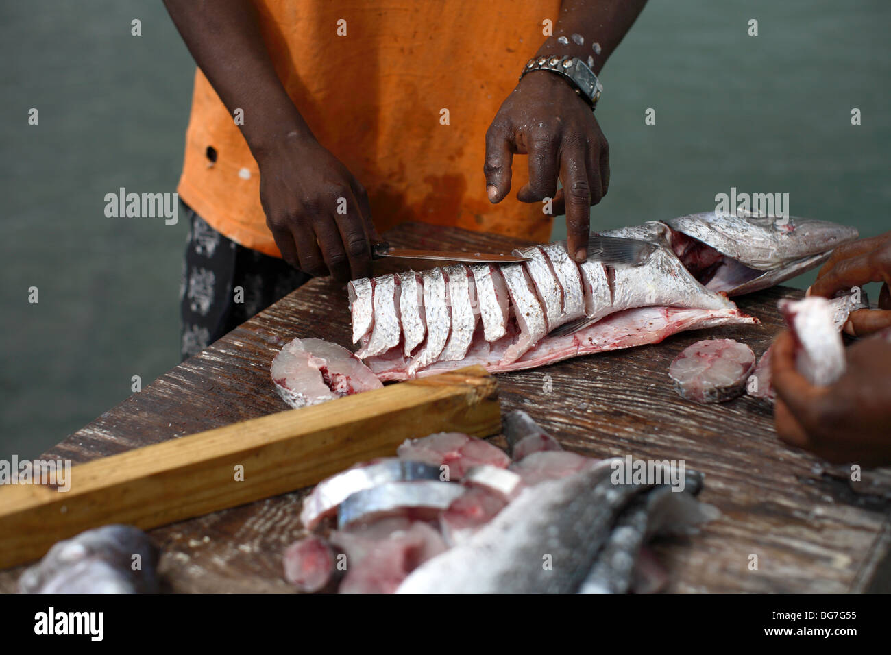 Fisherman cutting fish hi-res stock photography and images - Alamy