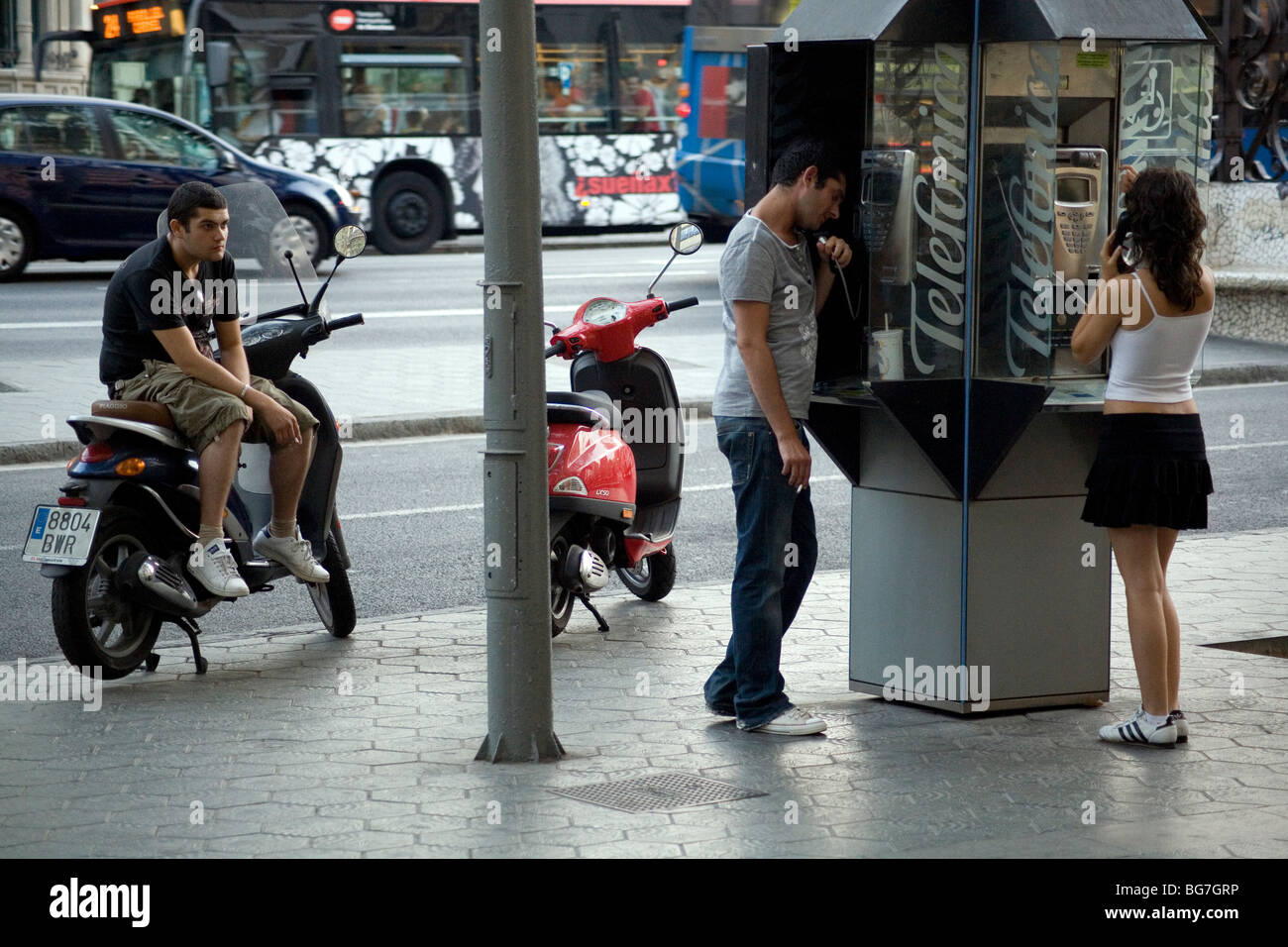 Young people hanging out public phone booths moped evening Barcelona ...