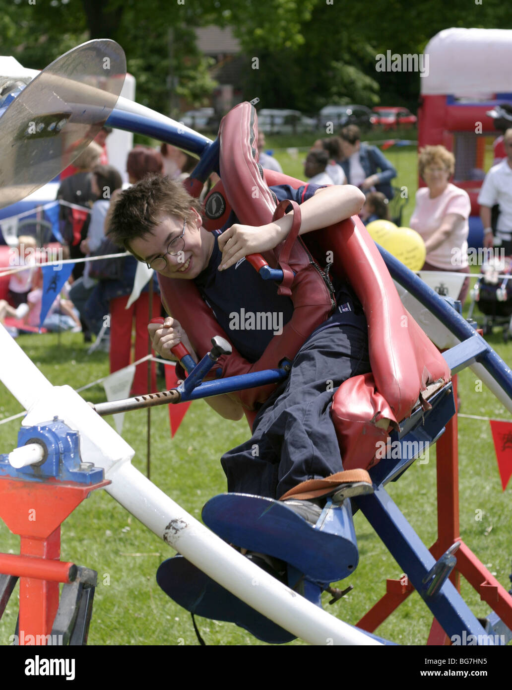 Young boy on a fairground ride Stock Photo - Alamy