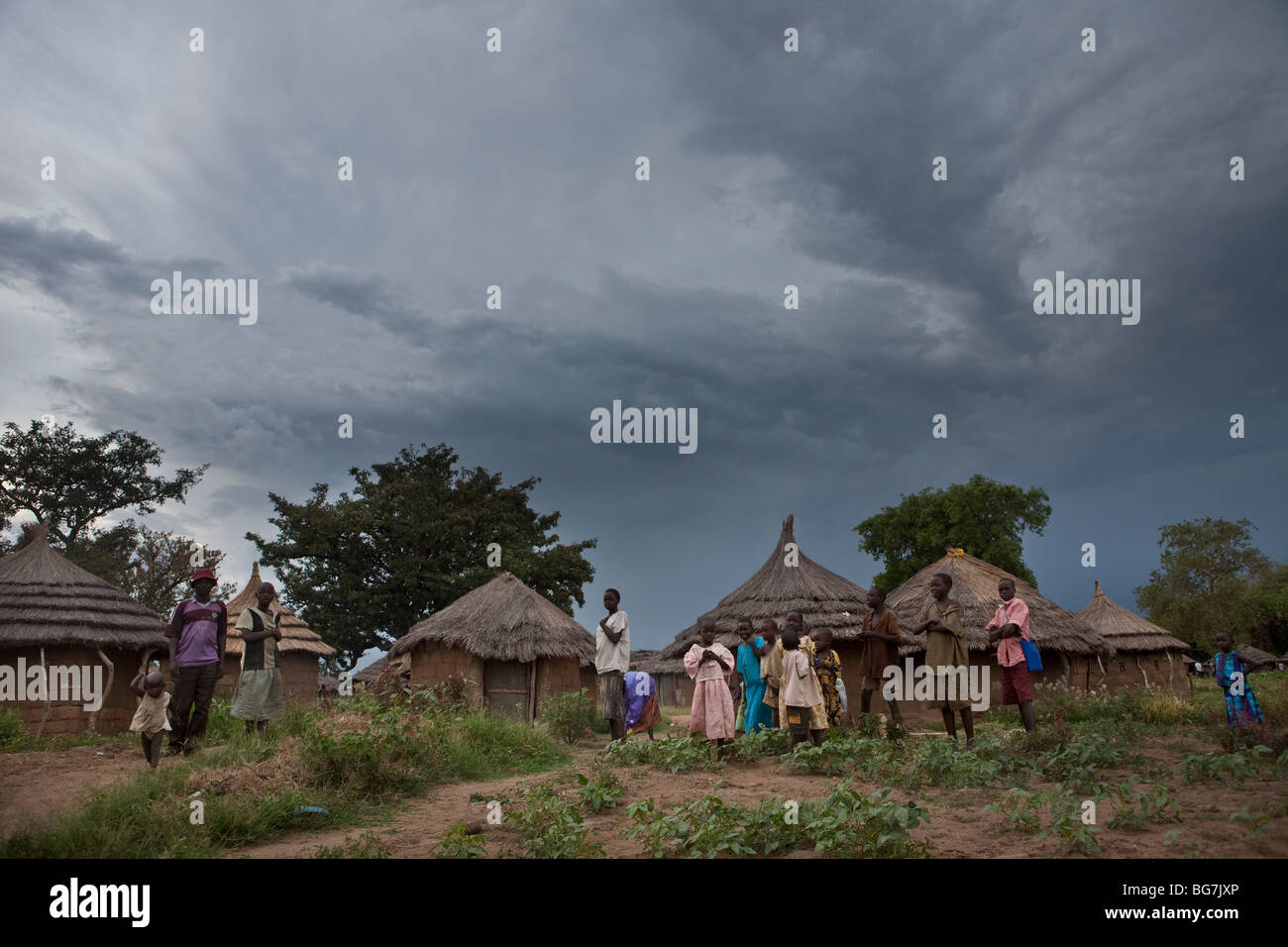 Residents stand outside their mud houses in Acowa refugee camp in ...