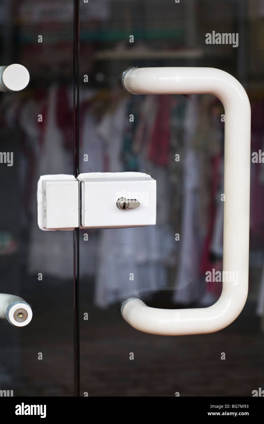 View of clothing store through closed glass door Stock Photo - Alamy