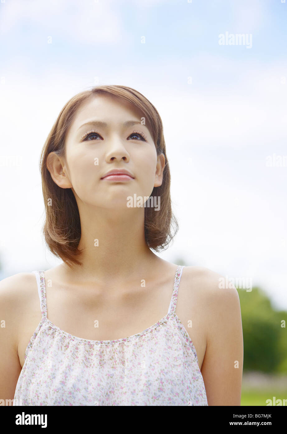 A young woman looking up Stock Photo - Alamy