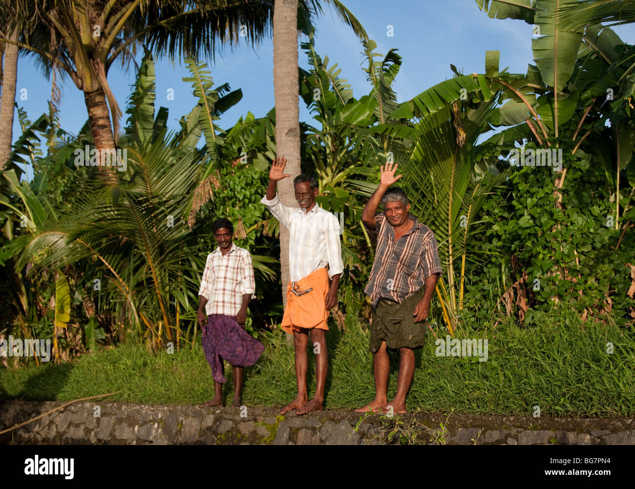 Indian men waving in Kerala Stock Photo - Alamy