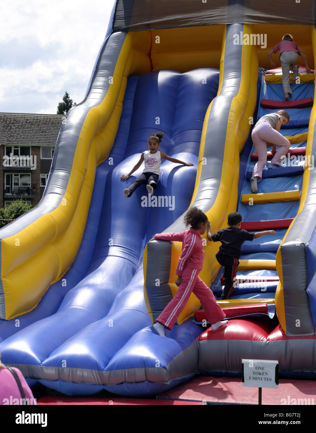 Young children on a fairground bouncy inflatable slide Stock Photo - Alamy