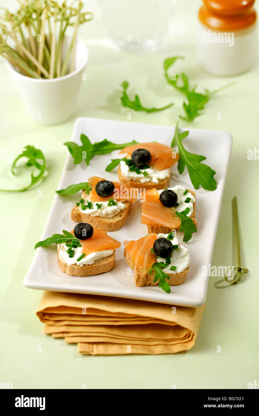 Little toasts with cheese and salmon. Recipe available Stock Photo - Alamy