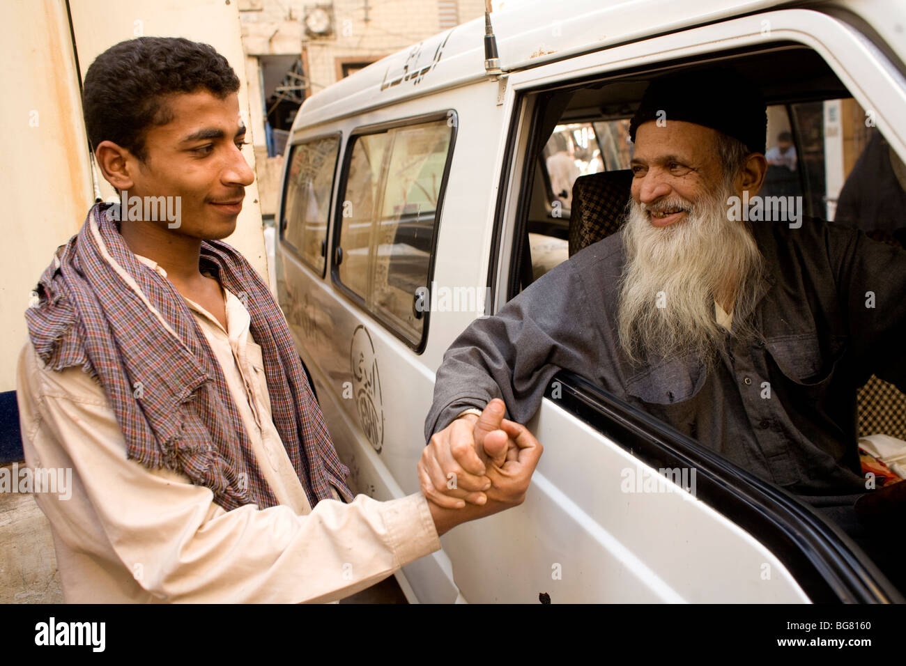 Two men shake hands in Karachi, Pakistan Stock Photo - Alamy