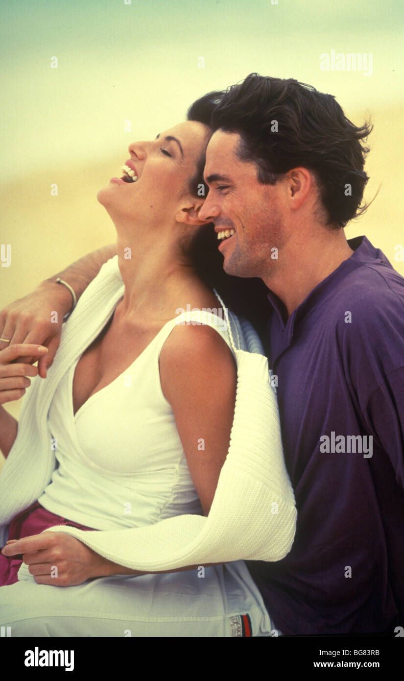 couple outside cuddling and laughing together Stock Photo - Alamy