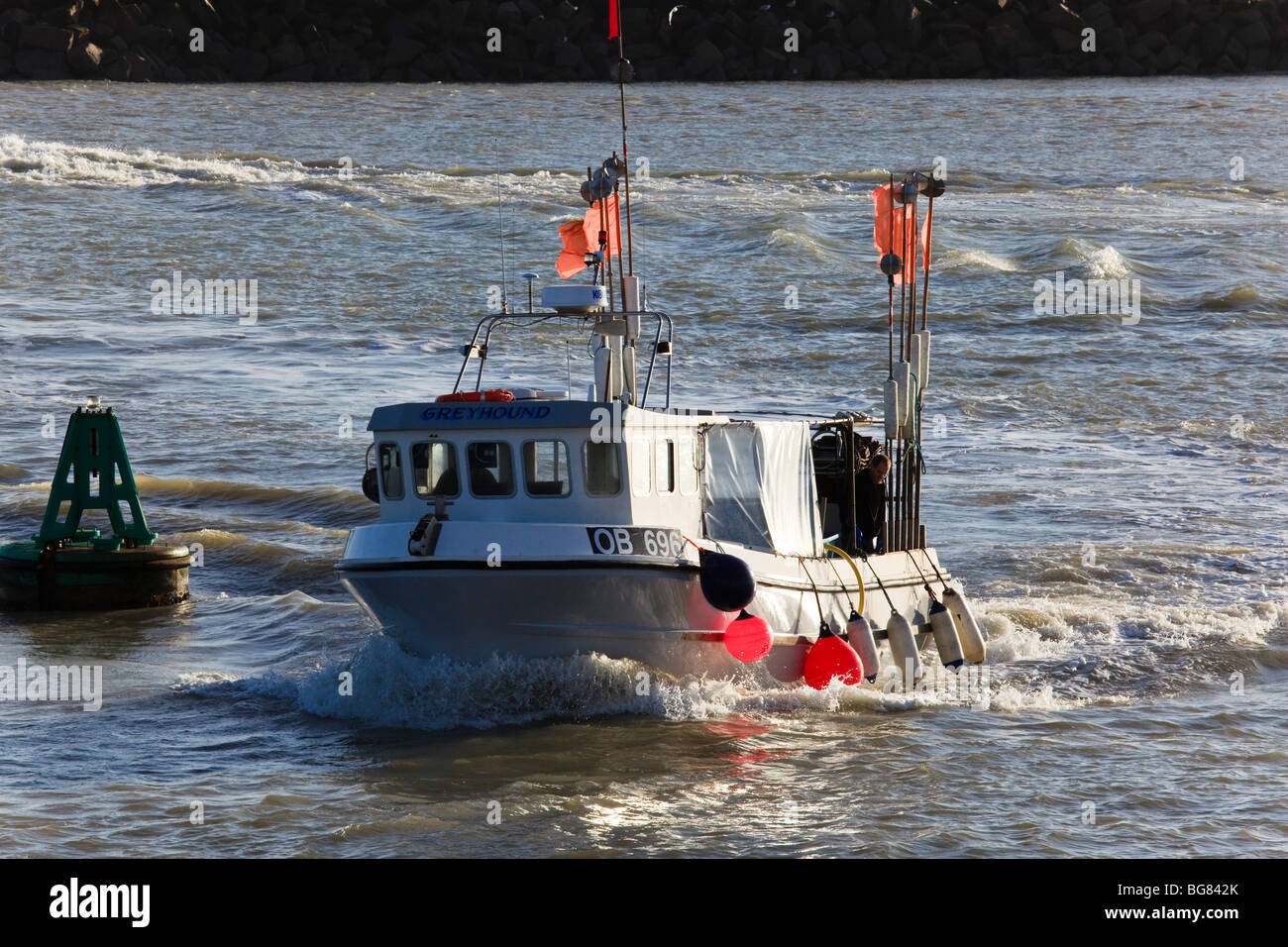 The small fishing boat "Greyhound" rounds a starboard buoy when ...