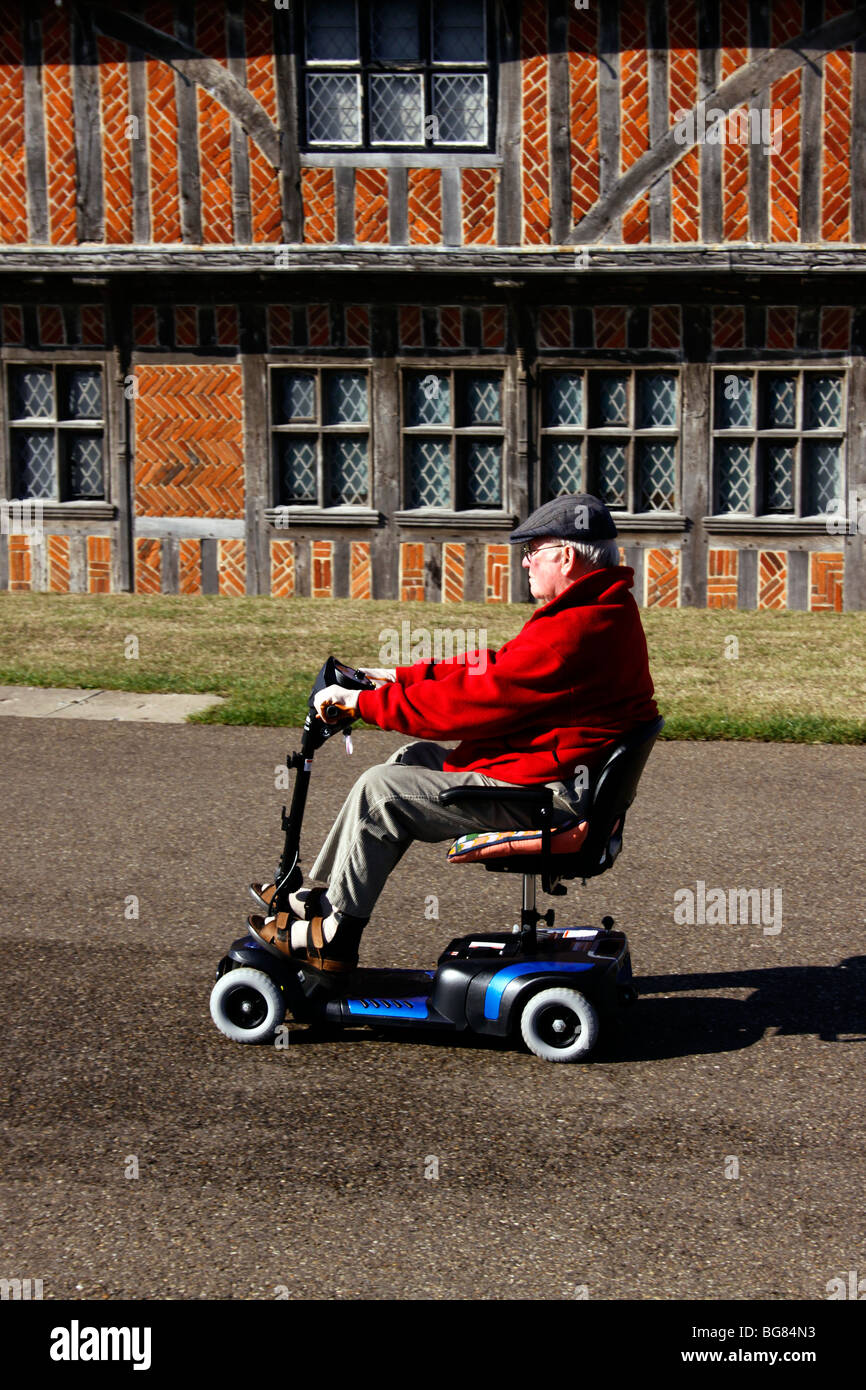 A SENIOR CITIZEN RIDING A MOBILITY SCOOTER Stock Photo - Alamy