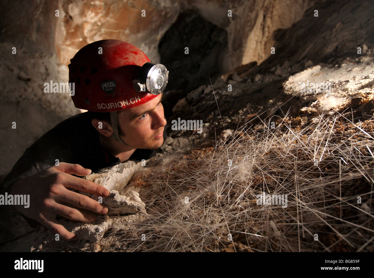 A cave explorer admires these unusual 'selenite needles' deep ...