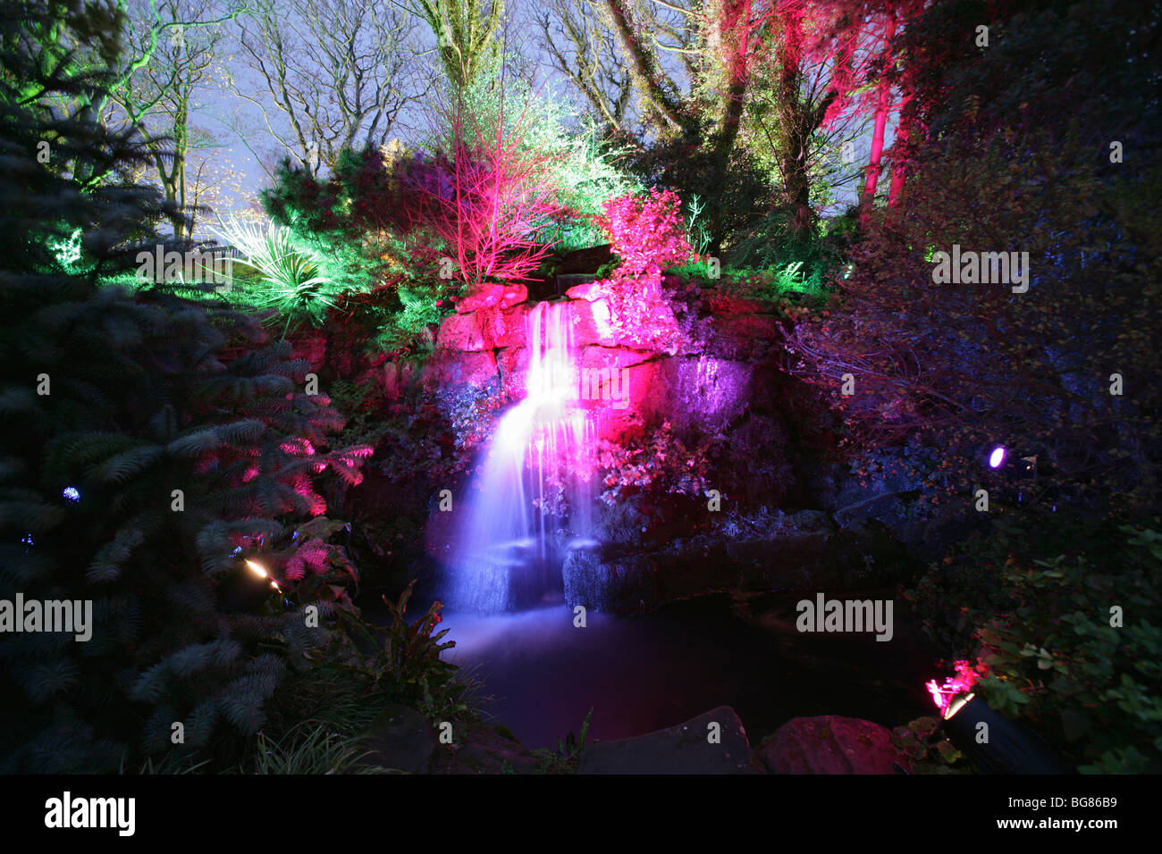 Evening floodlit view of an illuminated water feature waterfall at the ...
