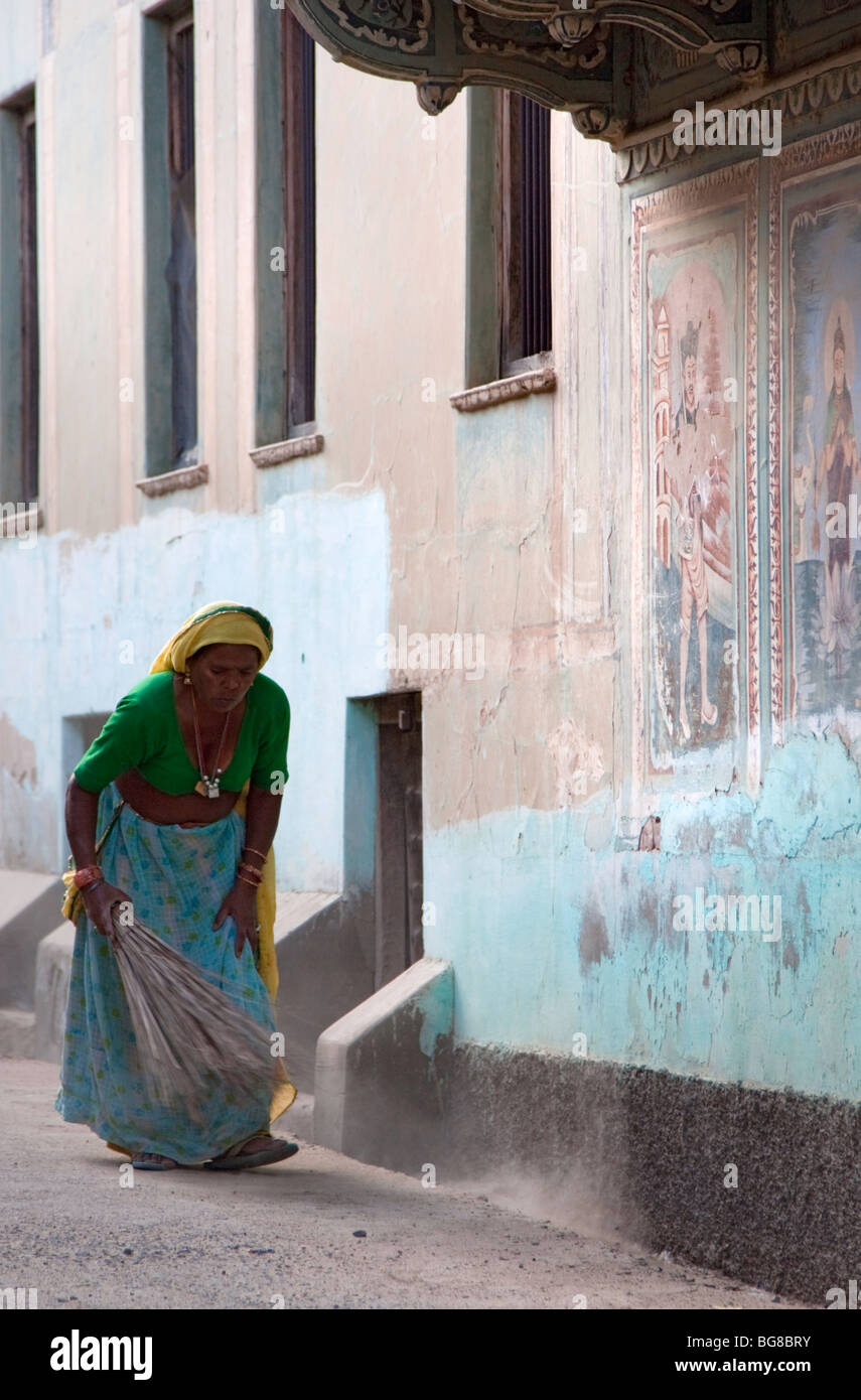 Indian woman sweeping path Stock Photo - Alamy