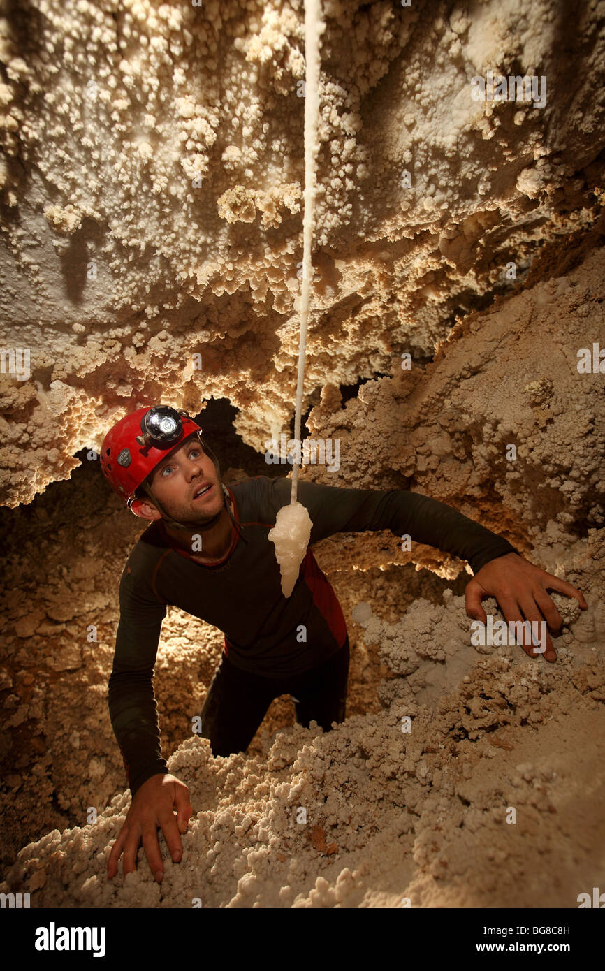 A British cave explorer admires a unique cave formation in the shape of ...