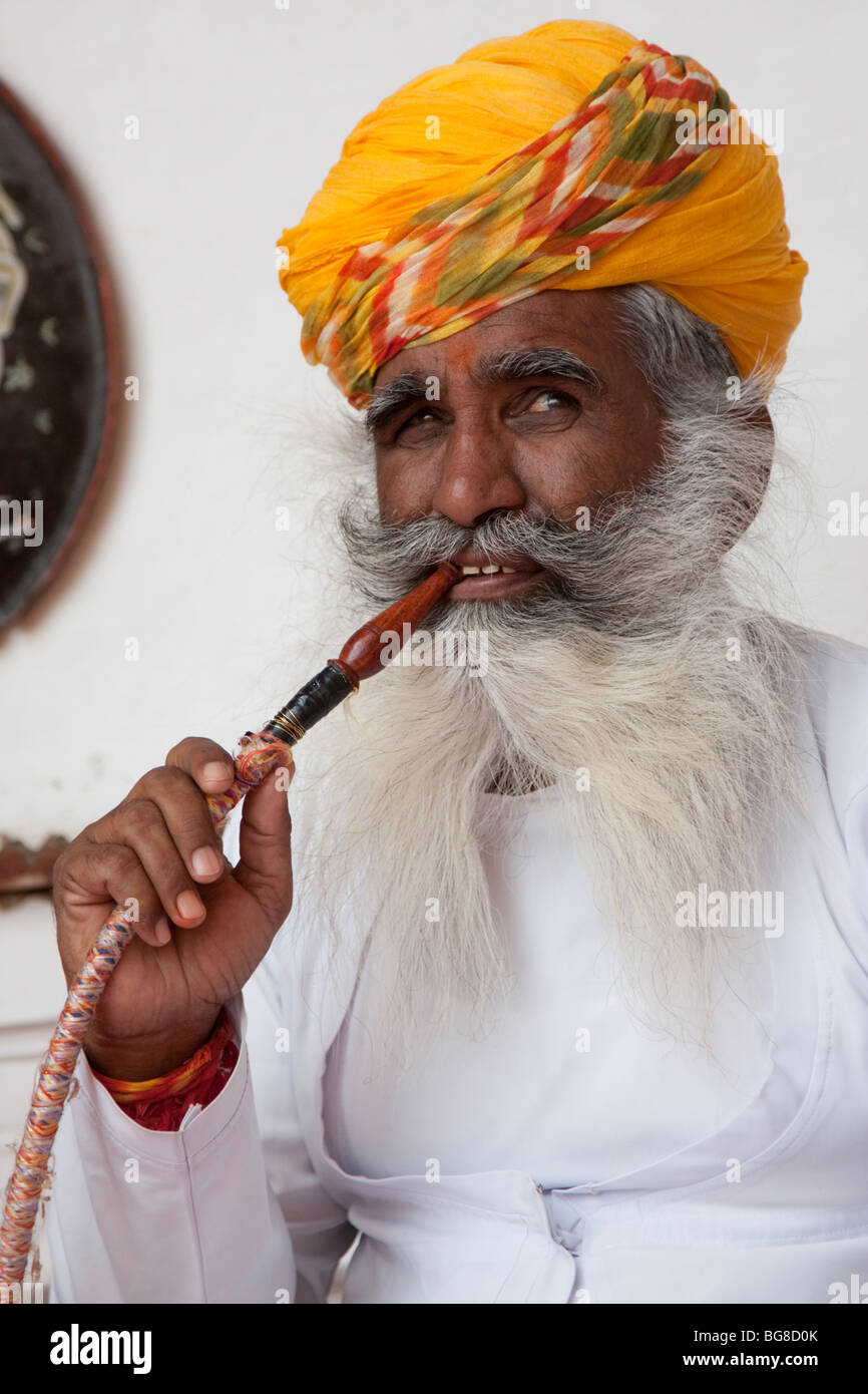 Indian man smoking hookah pipe Stock Photo - Alamy