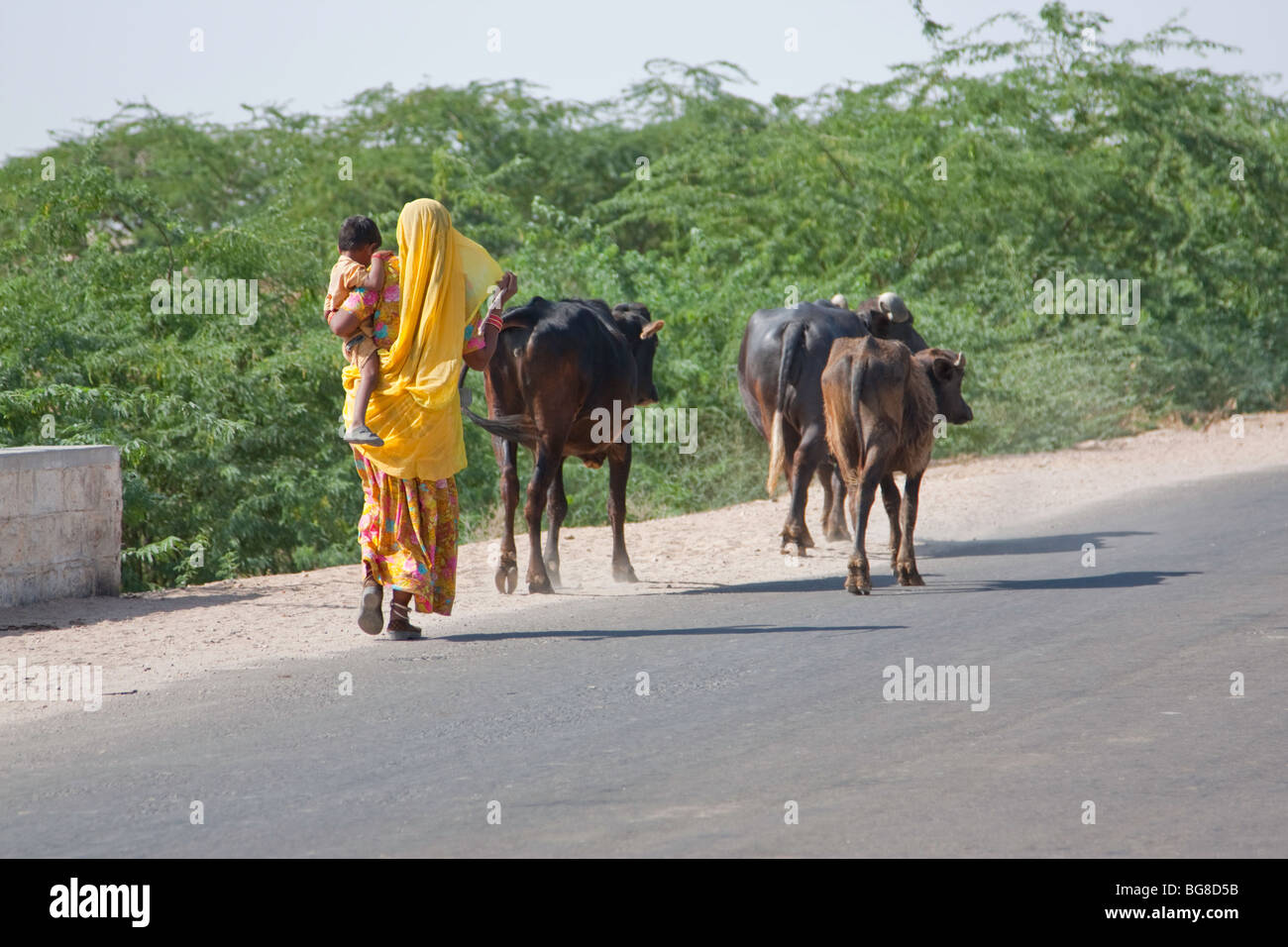 Indian woman carrying small child Stock Photo - Alamy