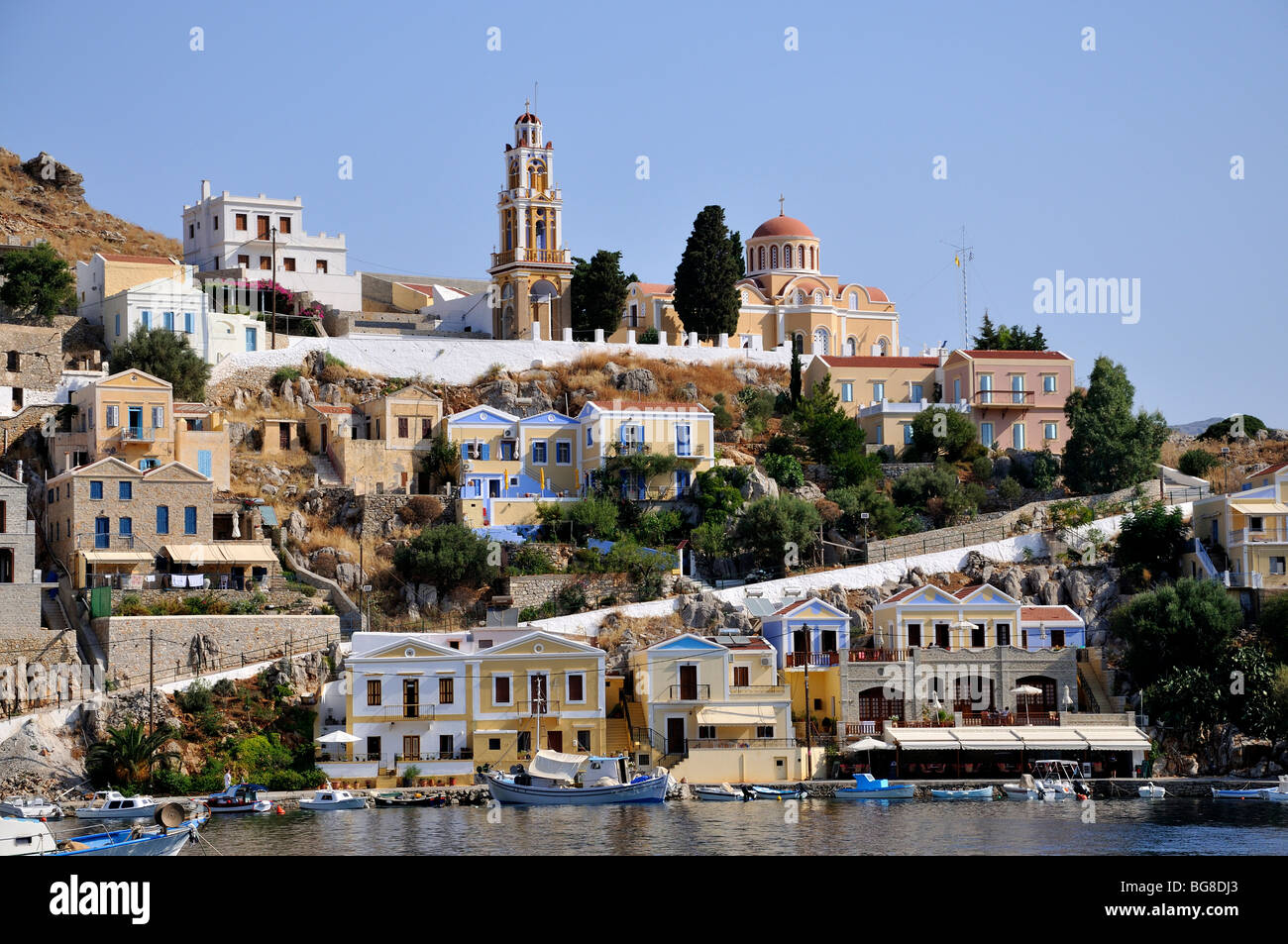 Colorful traditional houses and church at Symi town, Symi island ...