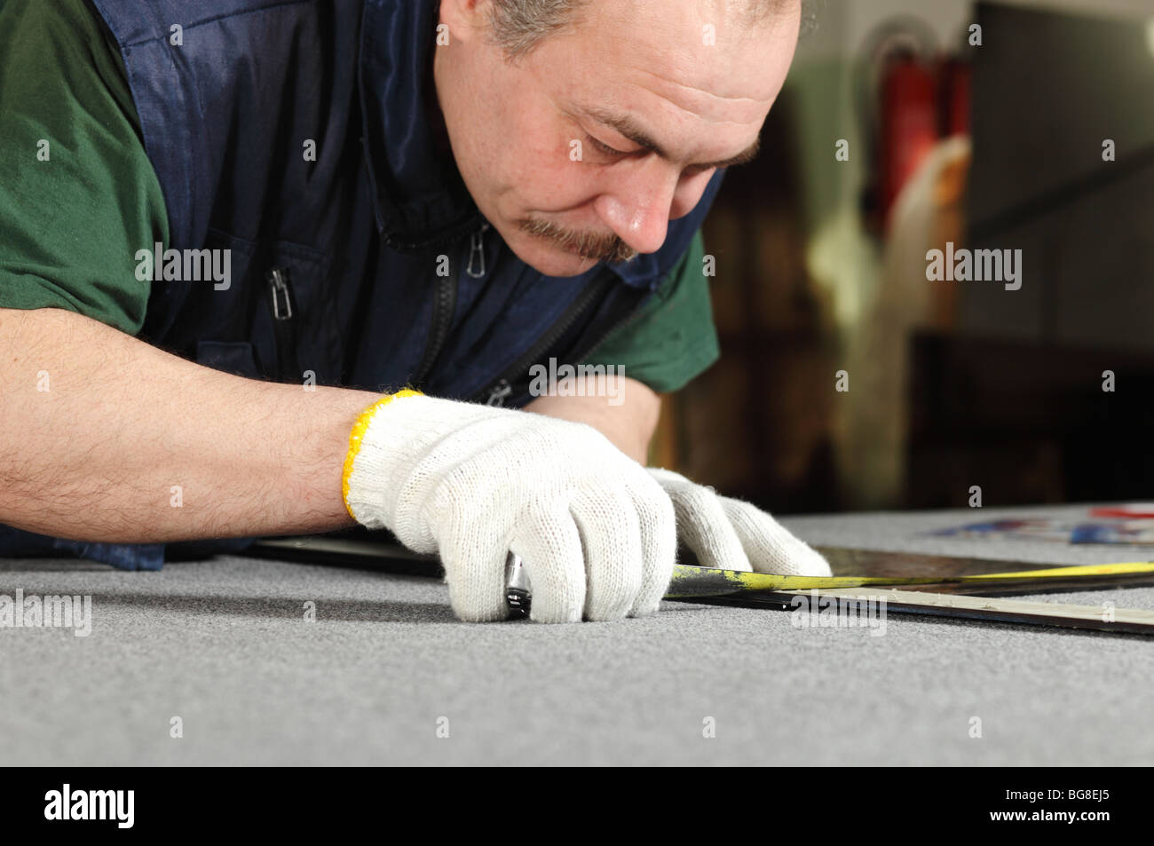 The worker, cutting a mirror,focus on a hand Stock Photo - Alamy