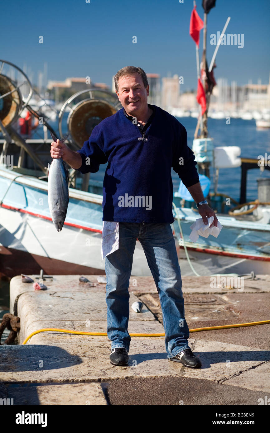 A fisherman shows off a fish he caught in Marseilles, France Stock ...