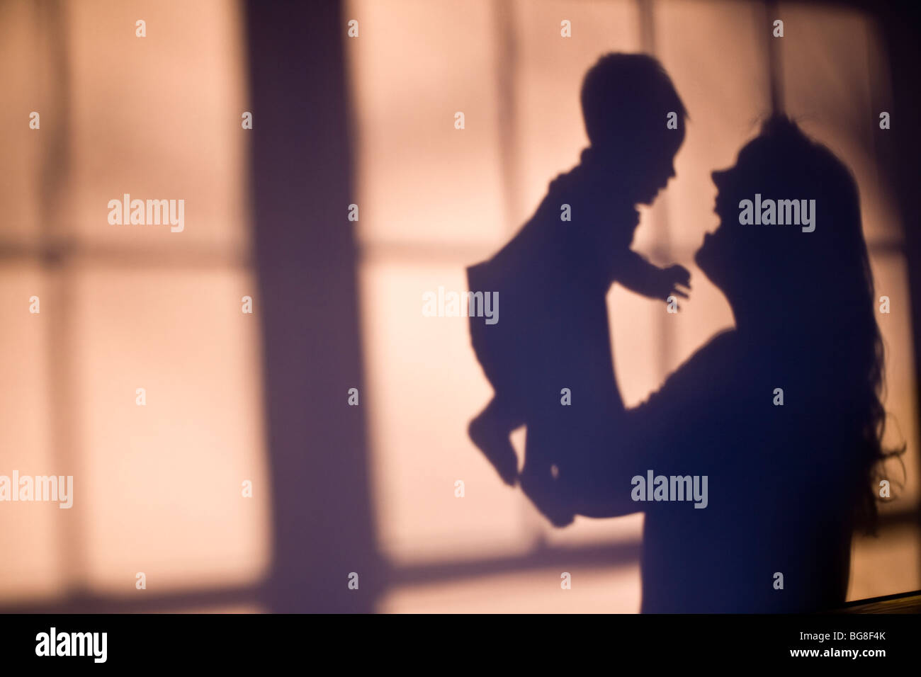The shadow of a mother holding her baby Stock Photo - Alamy