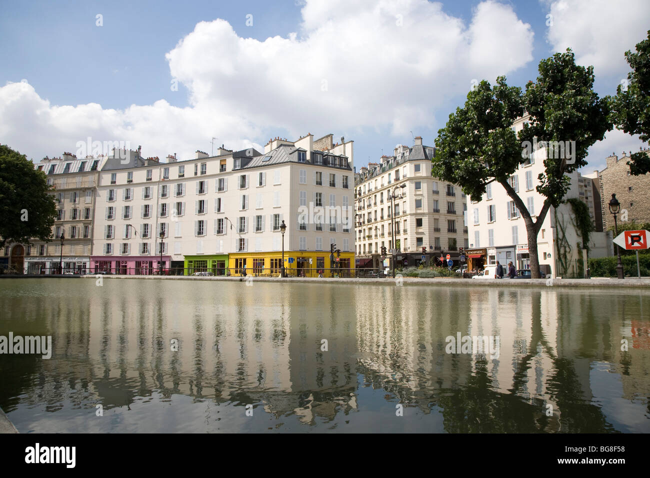 Buildings bordering a tree lined city canal Stock Photo - Alamy