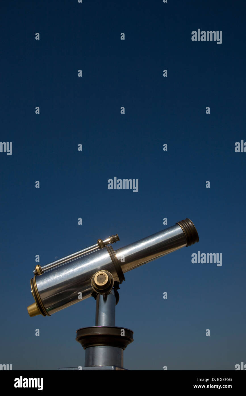 Telescope in blue sky pointing up Stock Photo - Alamy