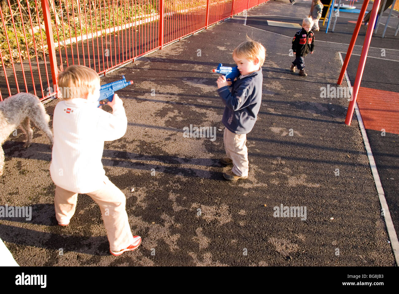 Boys play with toy guns in a playground Stock Photo - Alamy