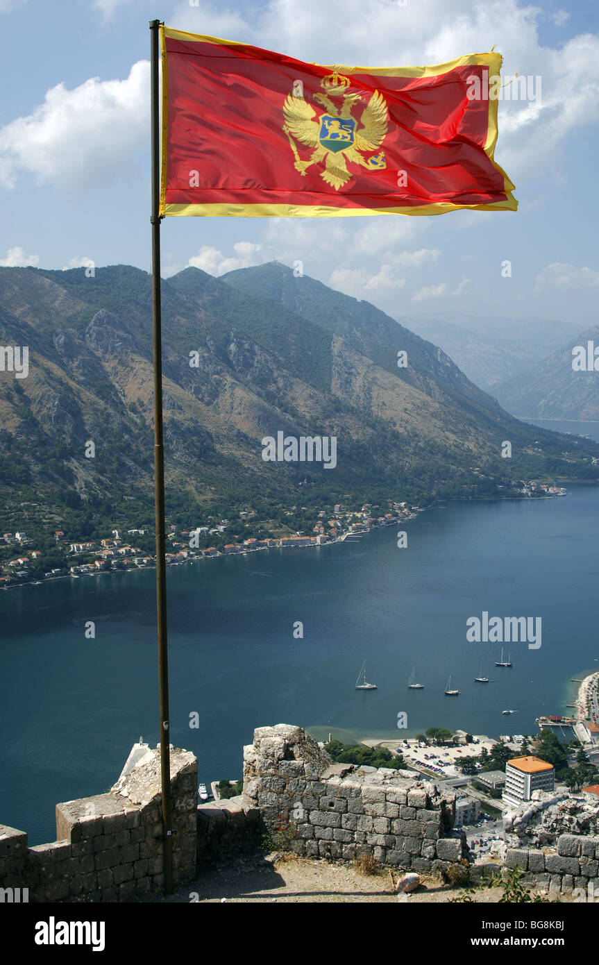 Flag of the Republic of Montenegro with the fjord at the background ...