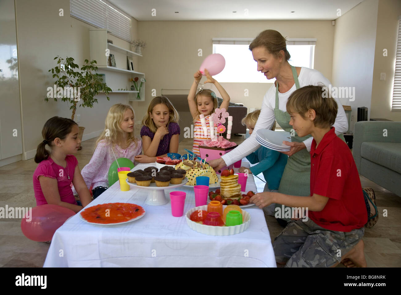 Small Children's - kids around table with sweets and cakes Stock Photo ...