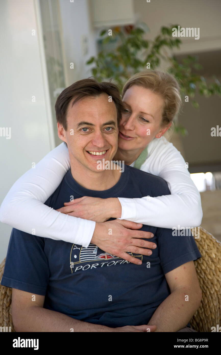 Happy Husband and Wife hugging one another Stock Photo - Alamy