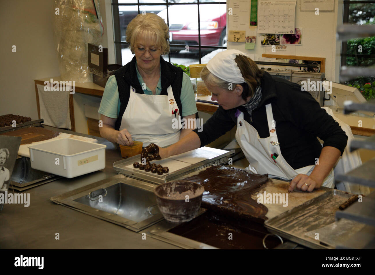 Two Ladies manufacturing chocolates at Boehms Chocolate Factory ...