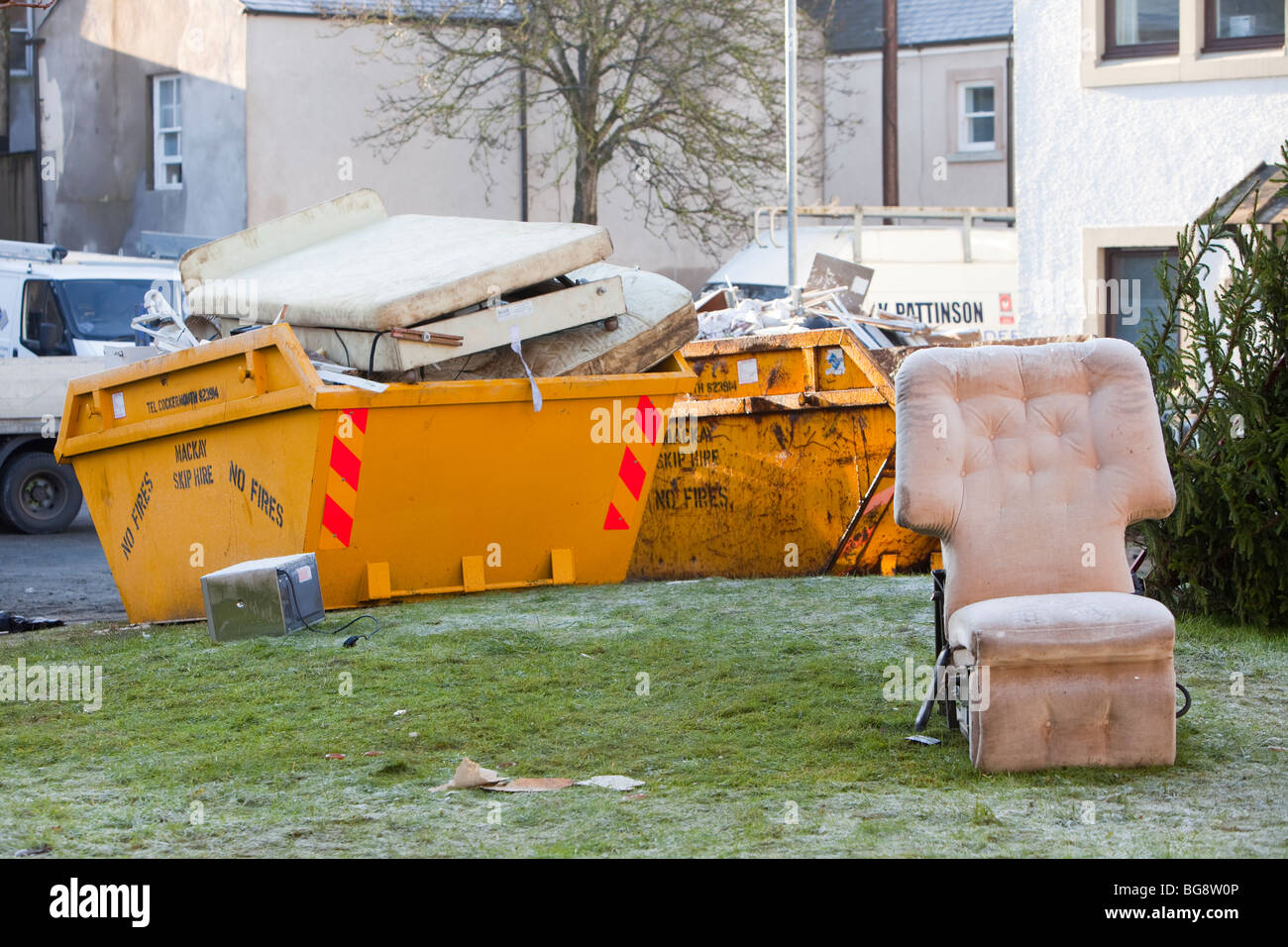 Skips with the contents of flood damaged houses in Cockermouth Stock ...