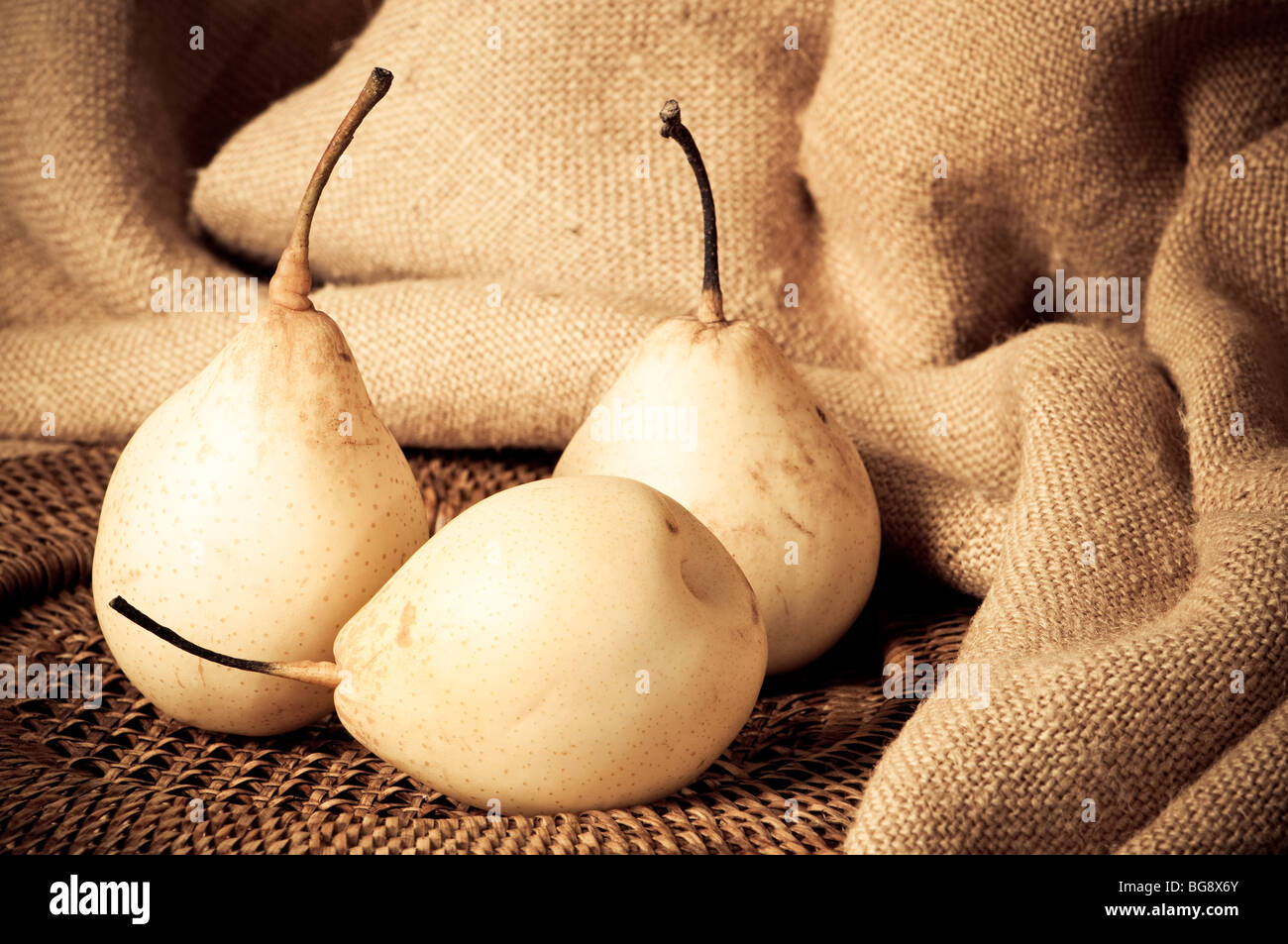 Pale yellow pears in high contrast setting Stock Photo - Alamy