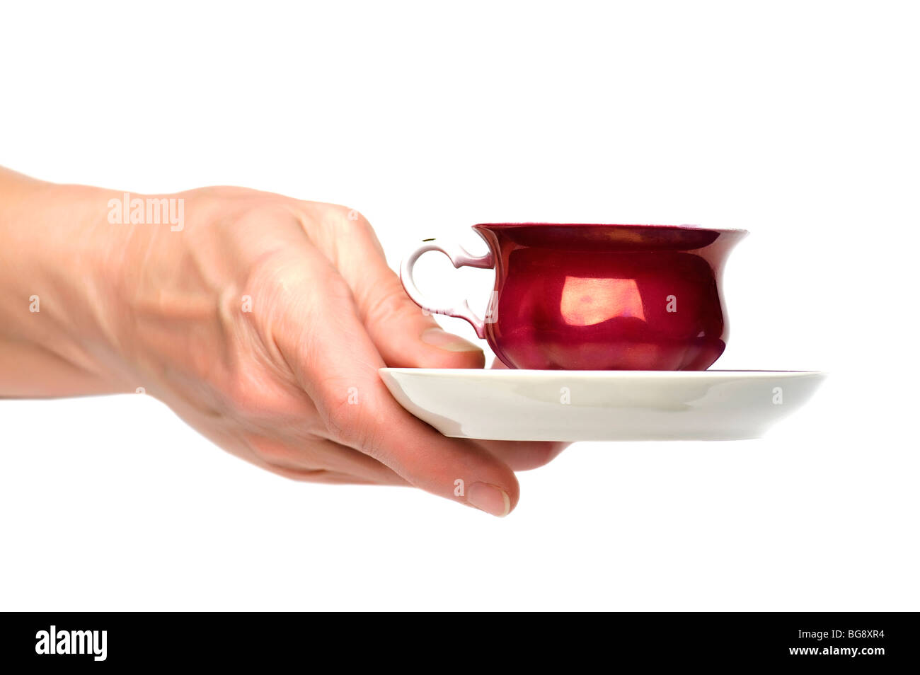 object on white cup of tea on hand Stock Photo - Alamy
