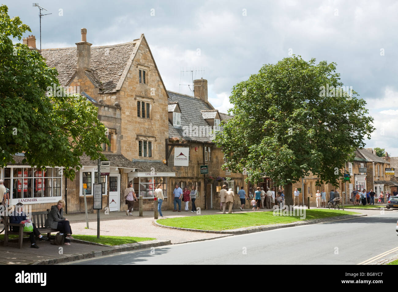 Traditional shop fronts along the High Street of the Cotswold town of ...