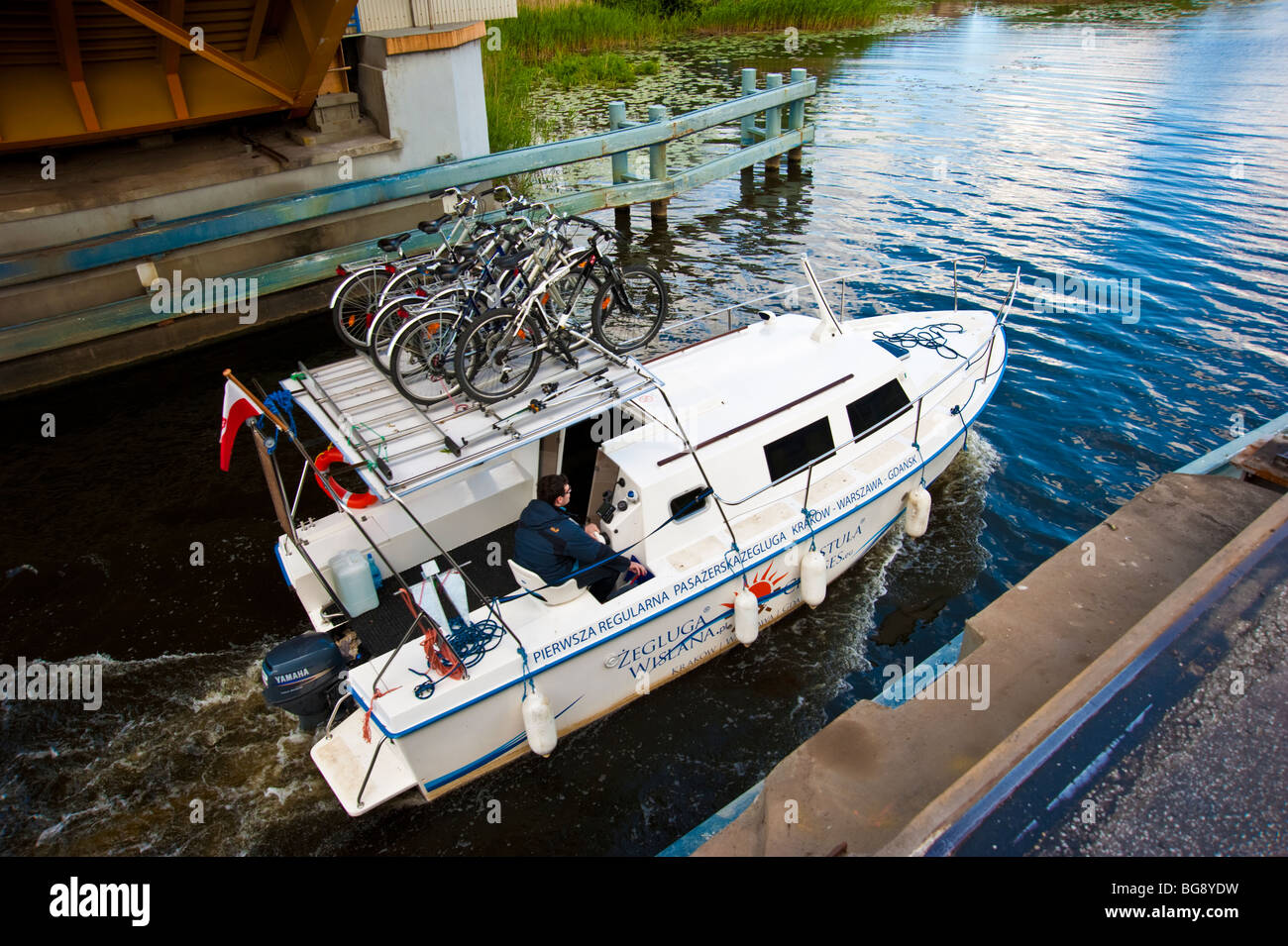 Charter yacht passing the drawbridge over Szkarpawa River / Elbinger ...