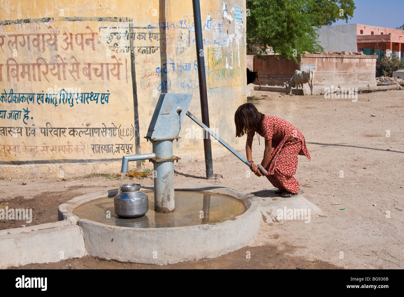 girl at water well Stock Photo - Alamy