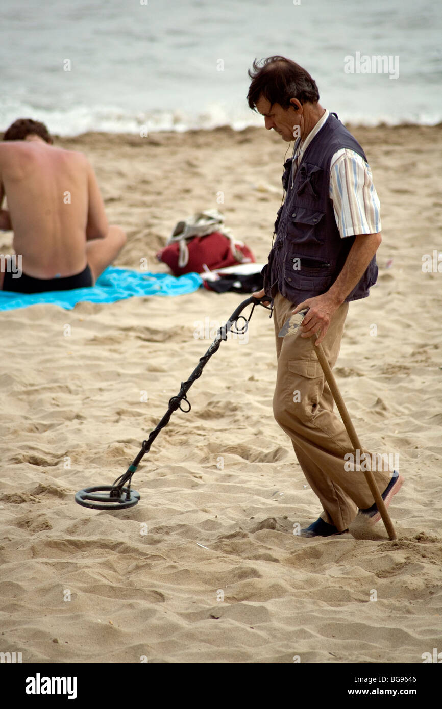 METAL DETECTOR, TOURIST BEACH, SPAIN: A man with a metal detector ...