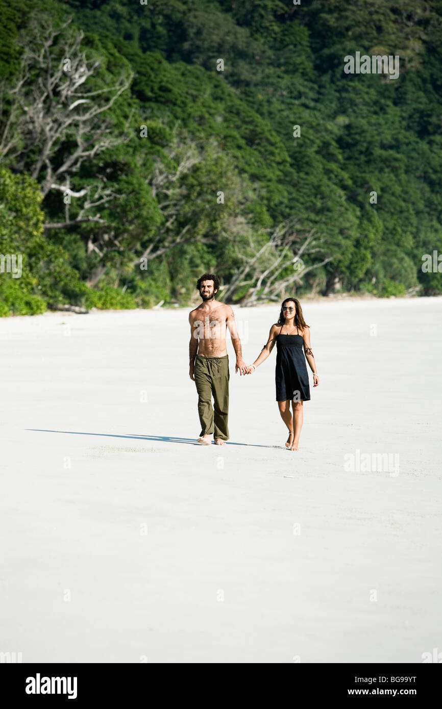 A couple walking on Beach number 9, voted as one of the most beautiful ...