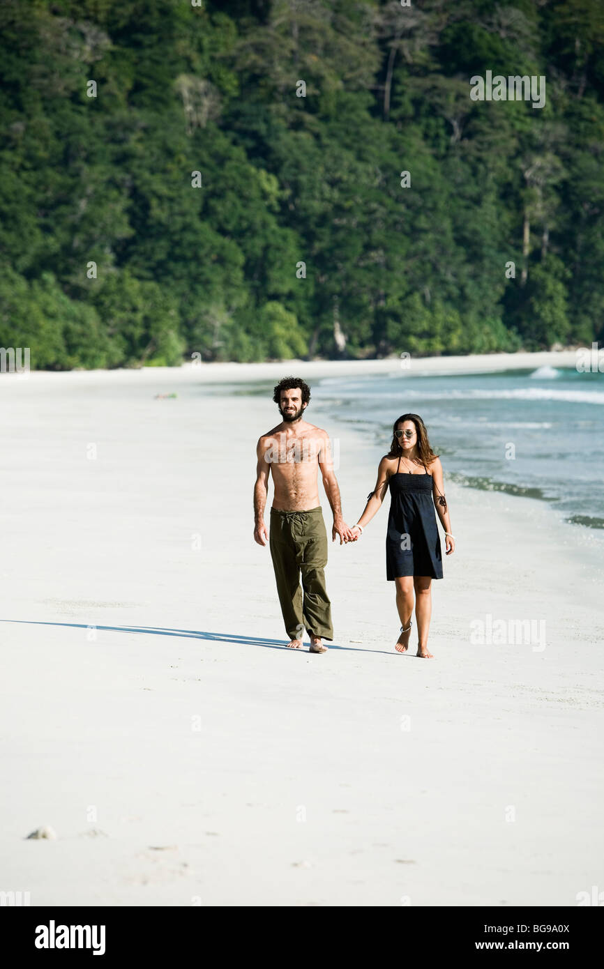 A couple walking on Beach number 9, voted as one of the most beautiful ...