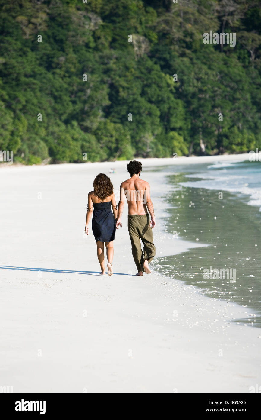 A couple walking on Beach number 9, voted as one of the most beautiful ...
