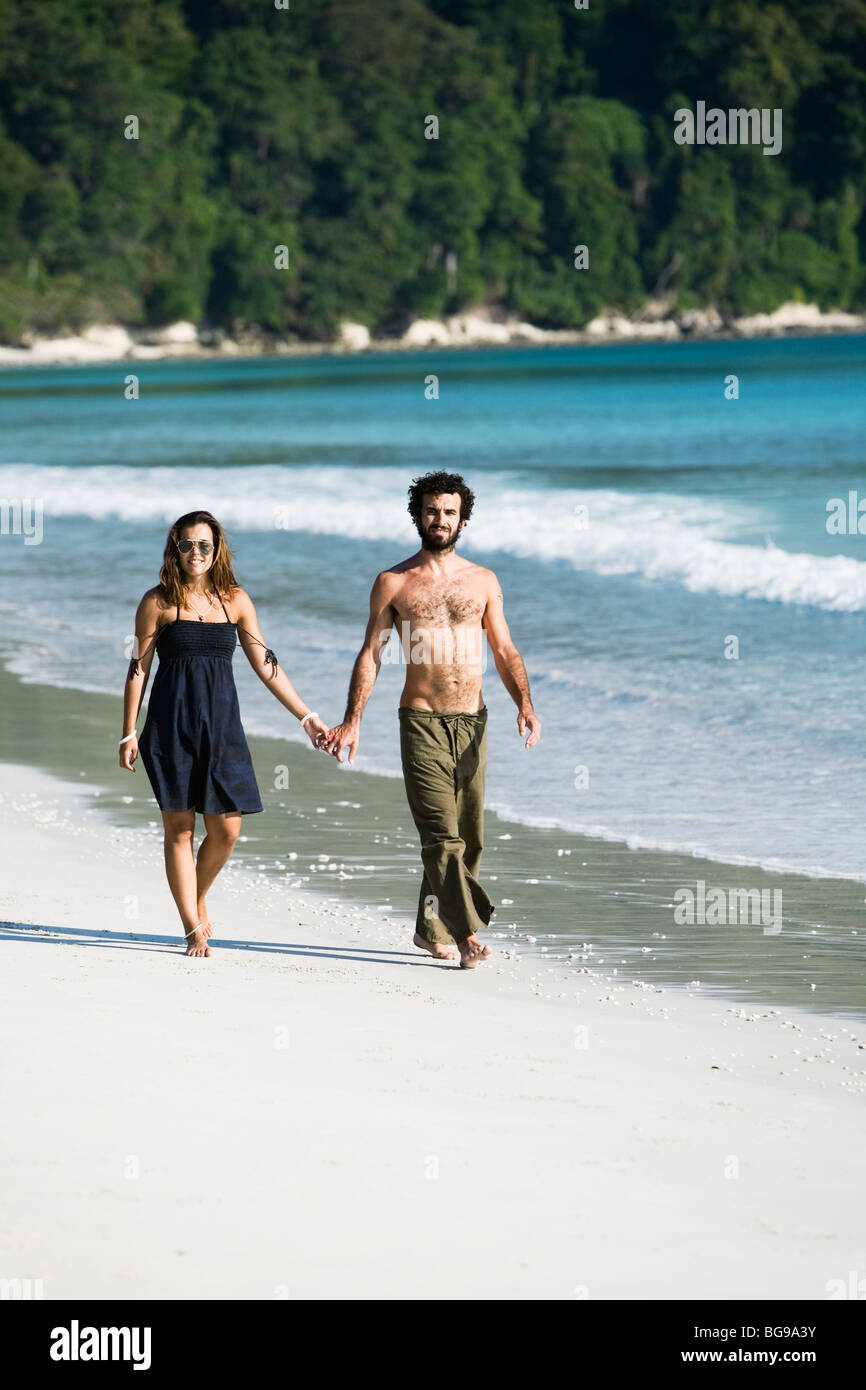 A couple walking on Beach number 9, voted as one of the most beautiful ...