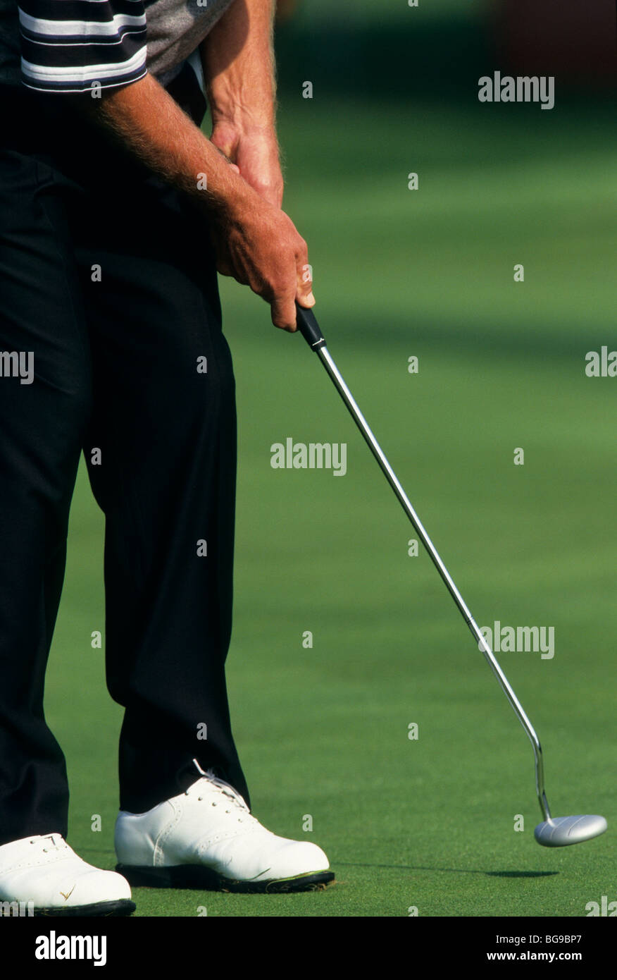 Golfer with a putter Stock Photo - Alamy