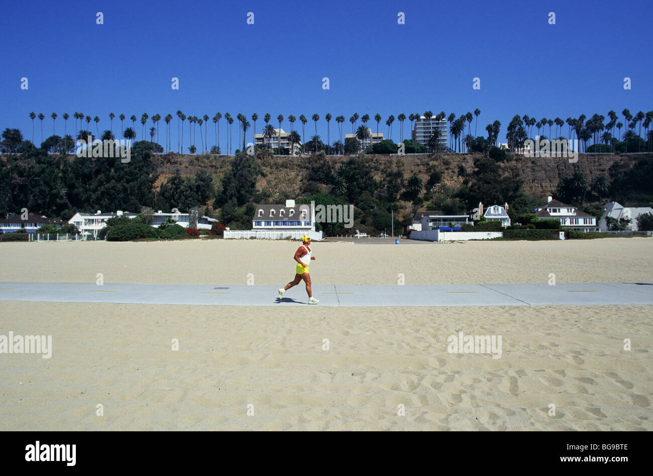 Man jogging on a beach path Stock Photo - Alamy