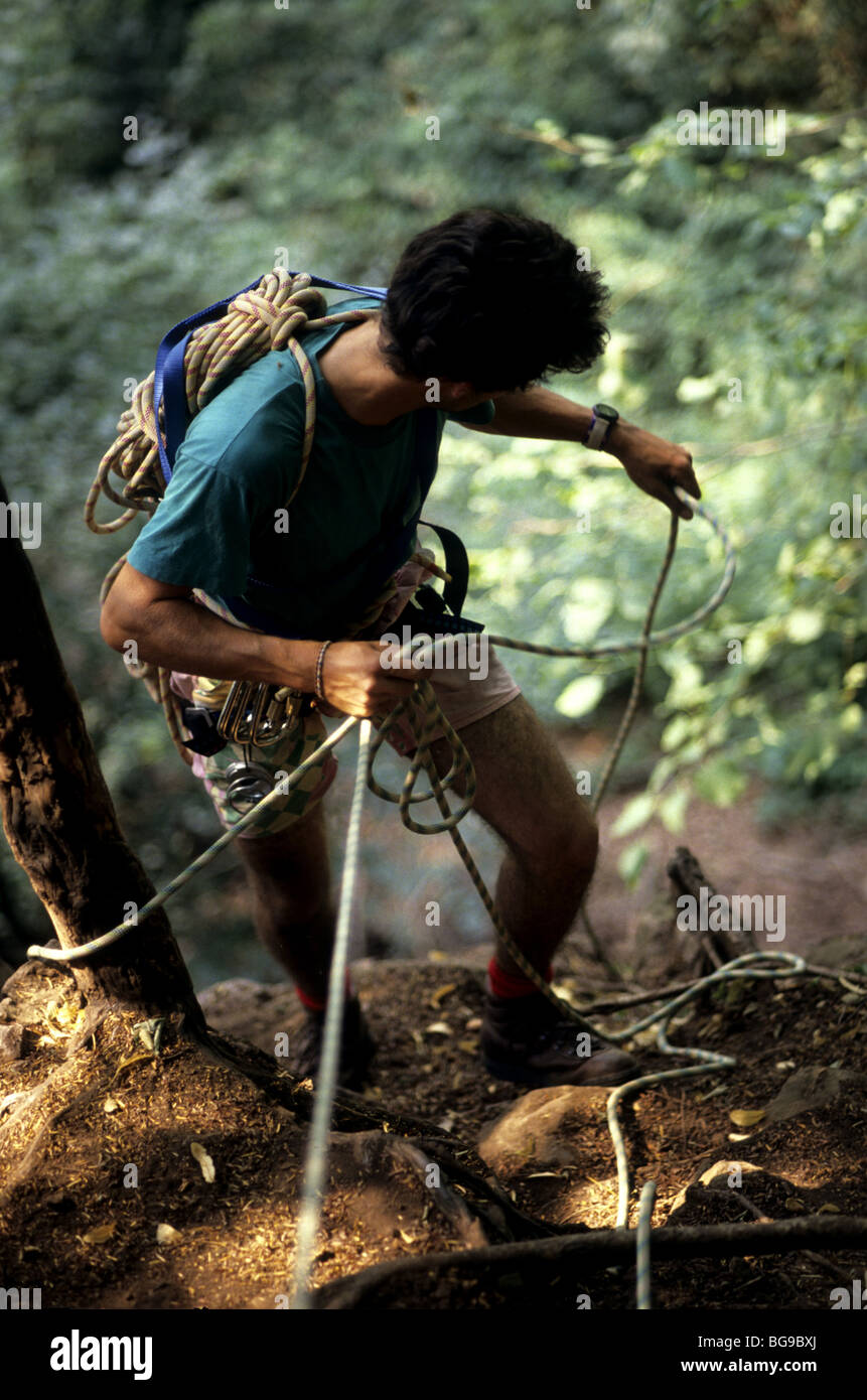 Man preparing to descend a hill side Stock Photo - Alamy