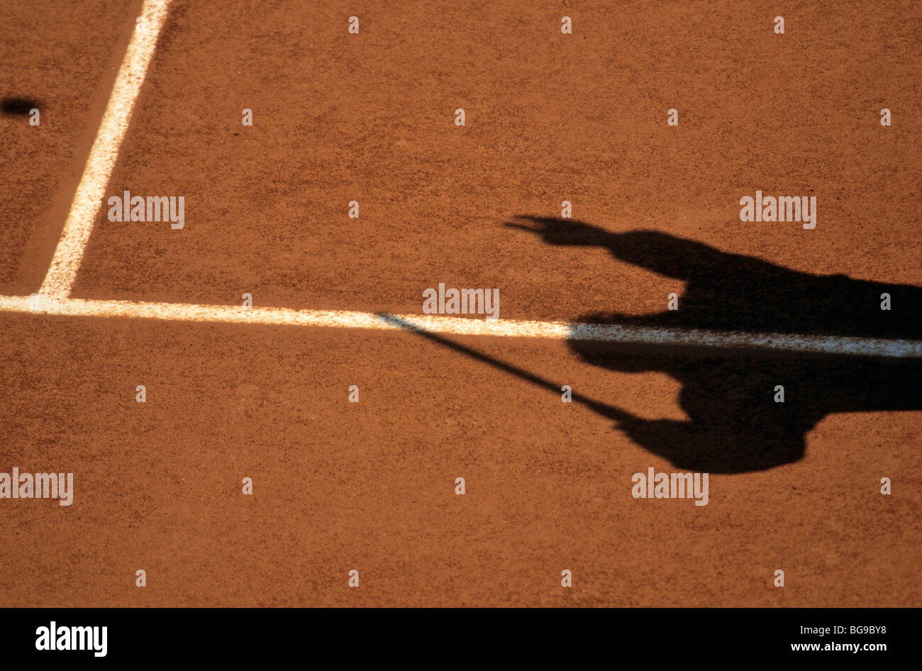 Shadow of a tennis player on a clay court Stock Photo - Alamy