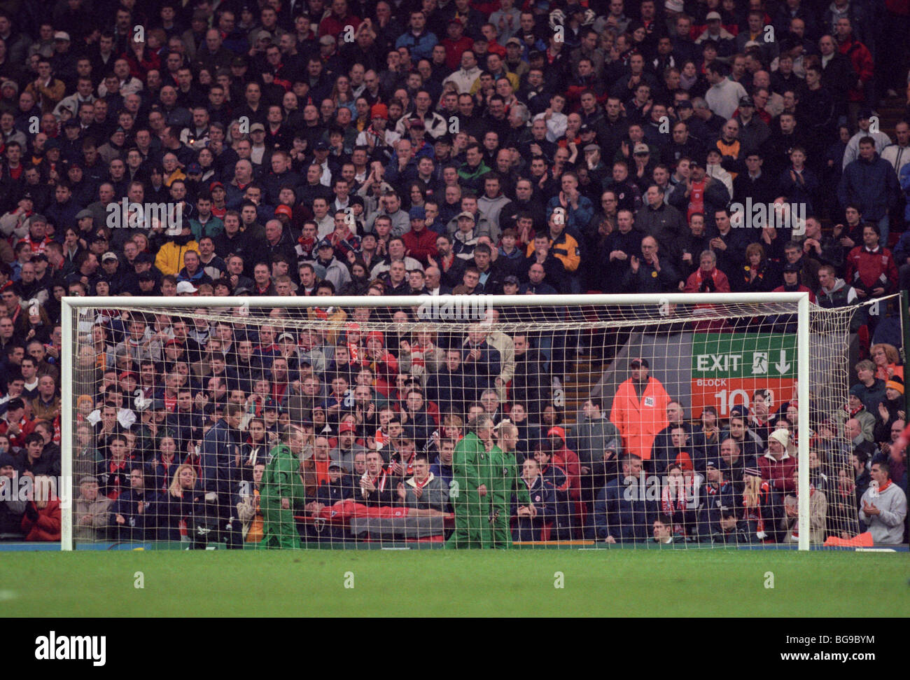 Crowd watch as football player is stretchered off behind the goal Stock ...