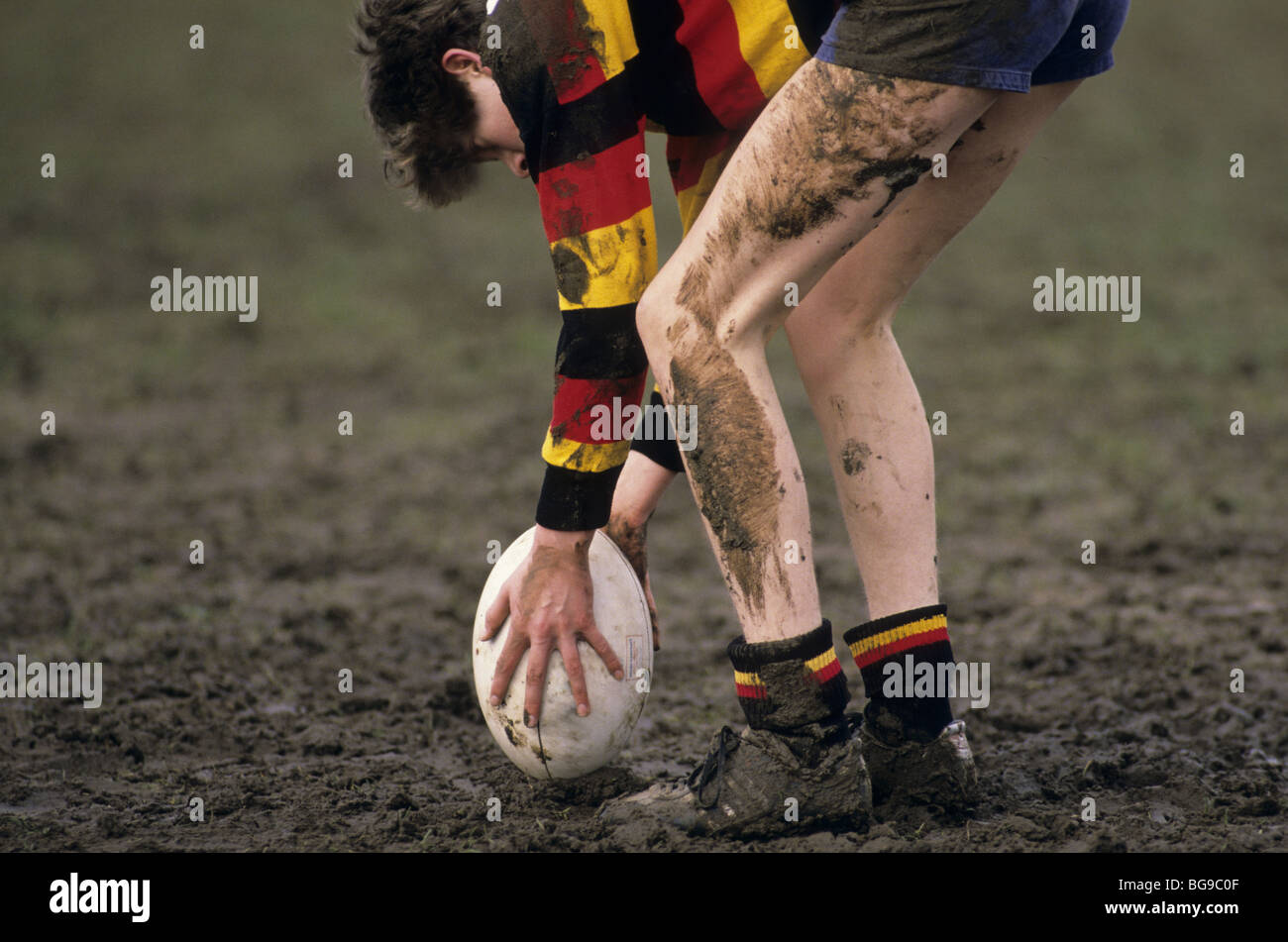 Teen rugby player placing the ball for a kick Stock Photo - Alamy