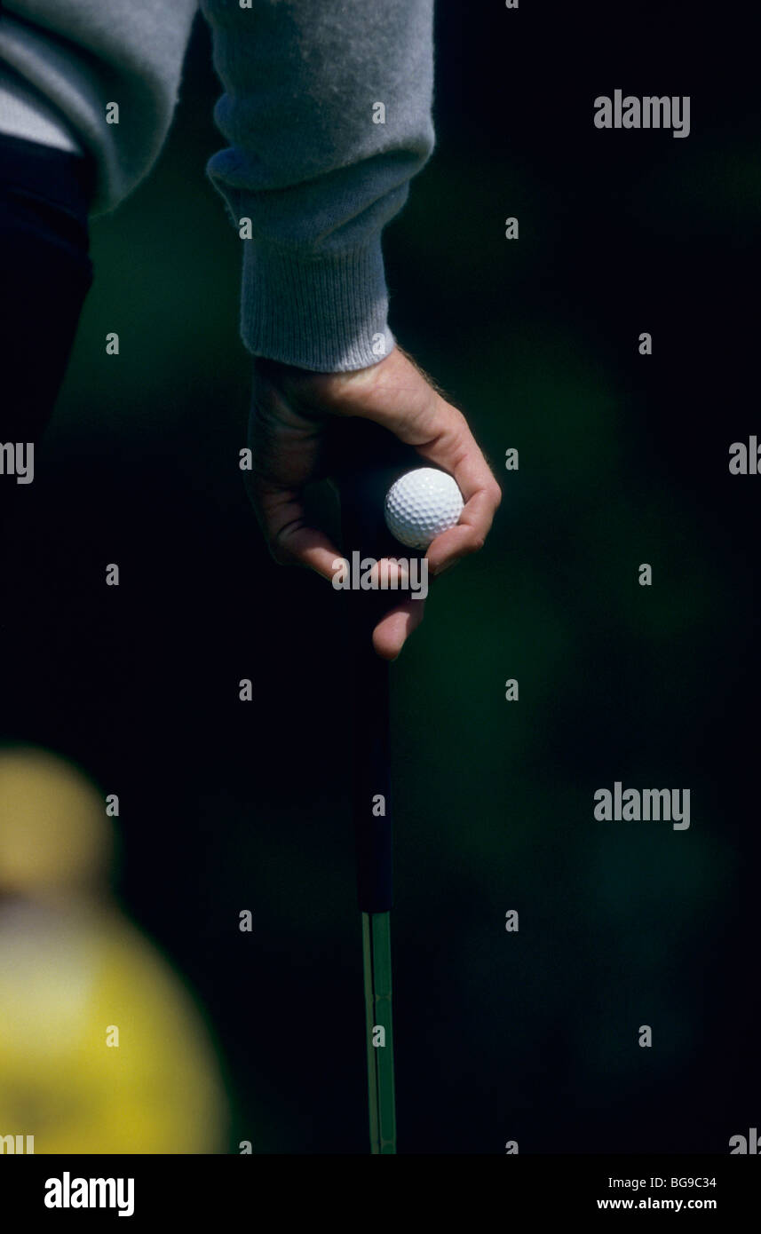 Close up of a golfer holding his club and a golf ball in one hand Stock ...